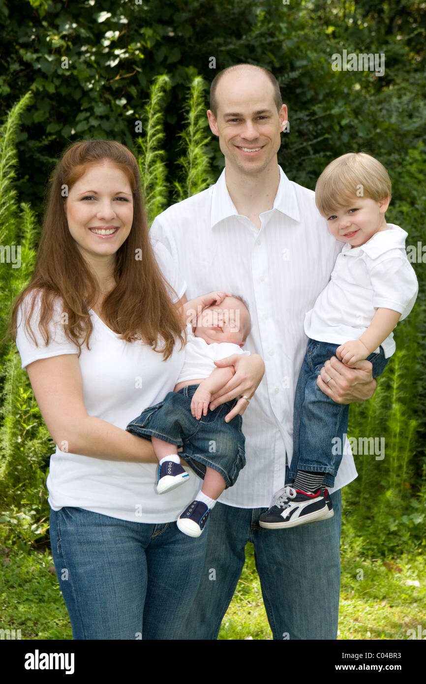 A traditional family of father, mother and two sons pose for a family ...