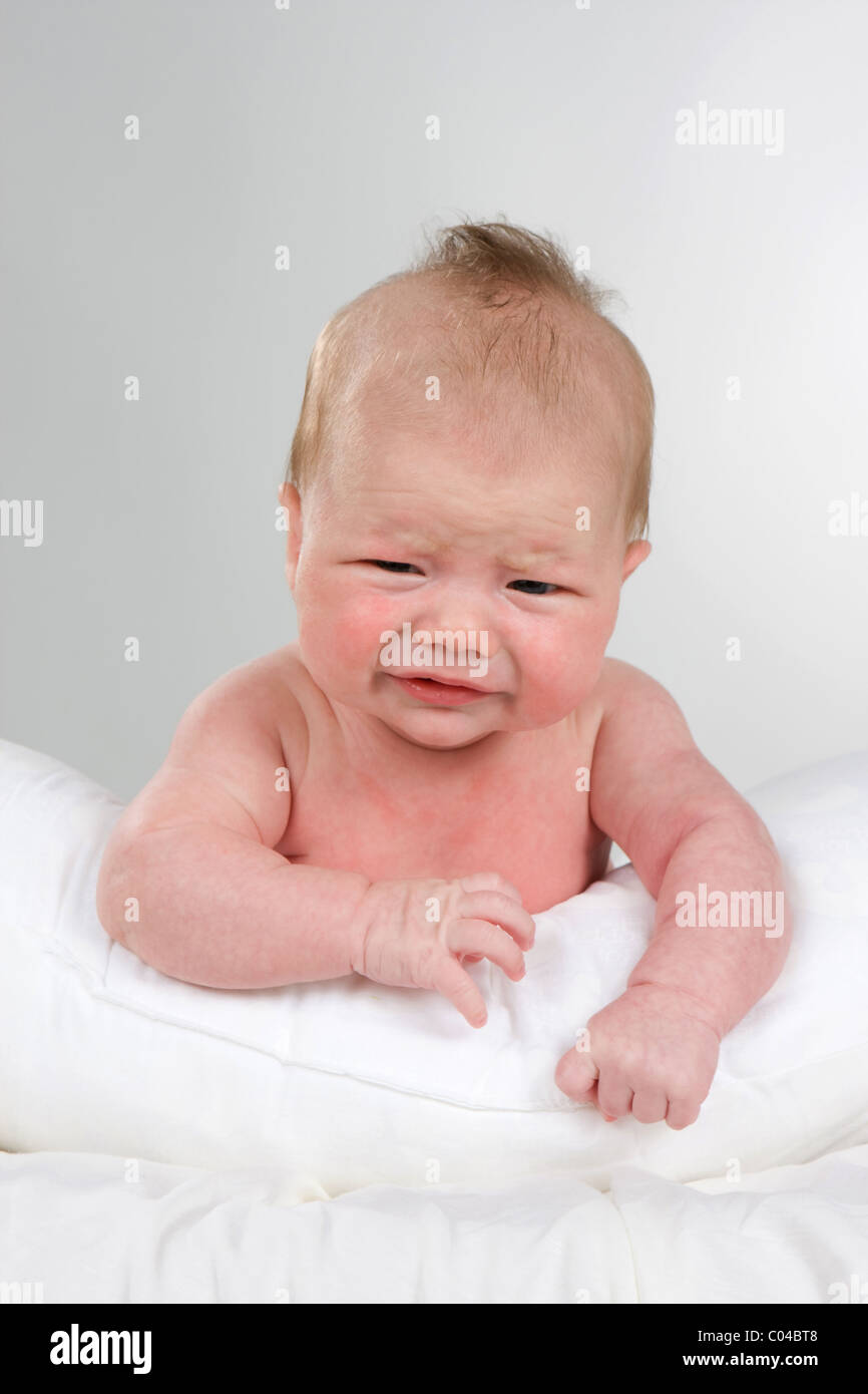 A newborn baby is somewhat unhappy in this position Stock Photo - Alamy