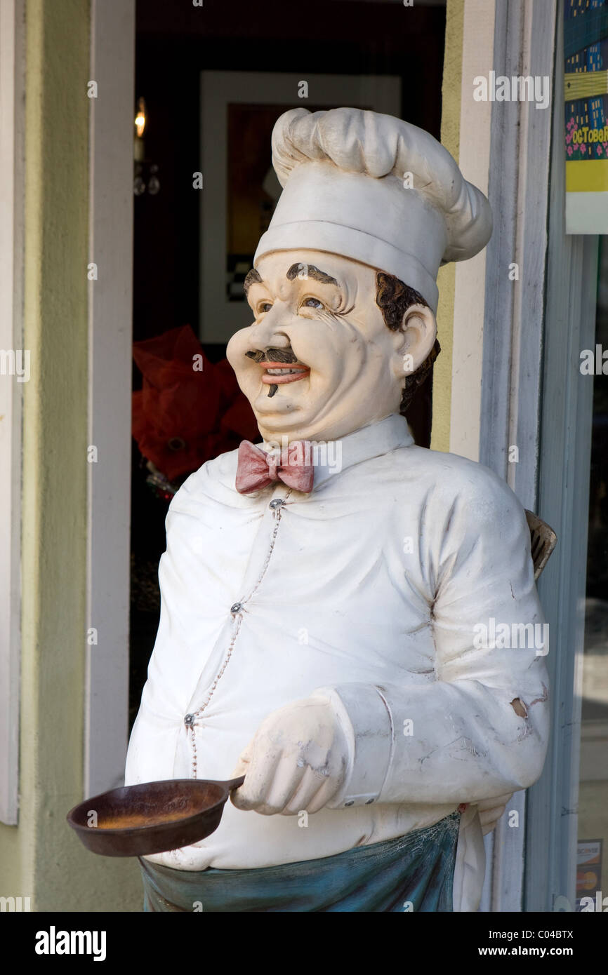 Vintage baker statue holding pan in front of bakery store Stock Photo ...