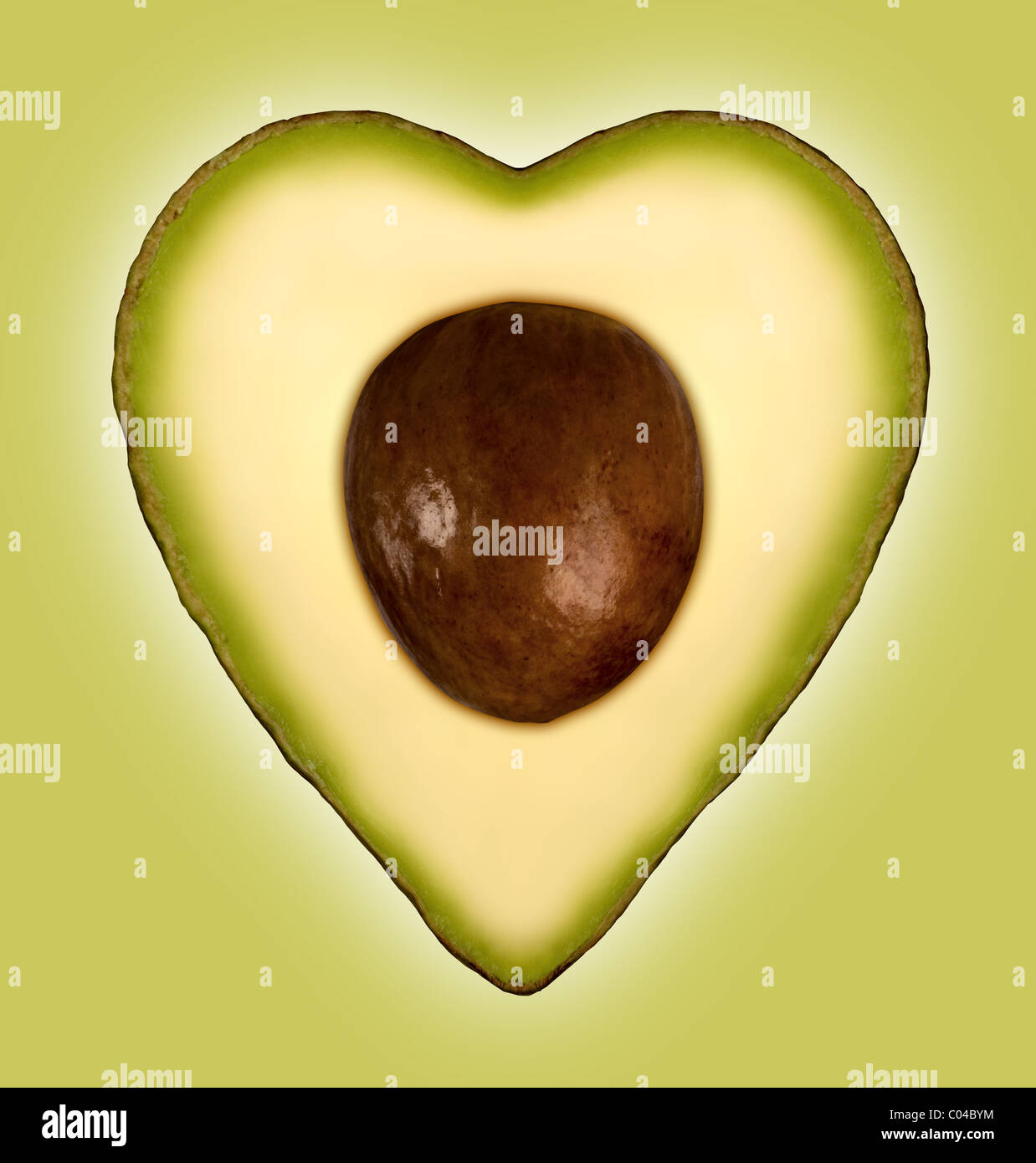 a avocado with a heart shape on a green background Stock Photo - Alamy