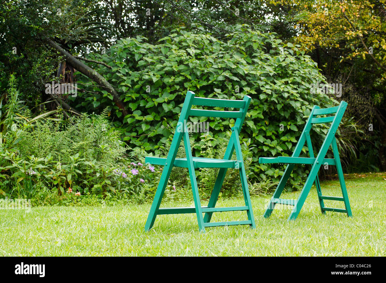 Two green folding garden chairs on the lawn Stock Photo - Alamy