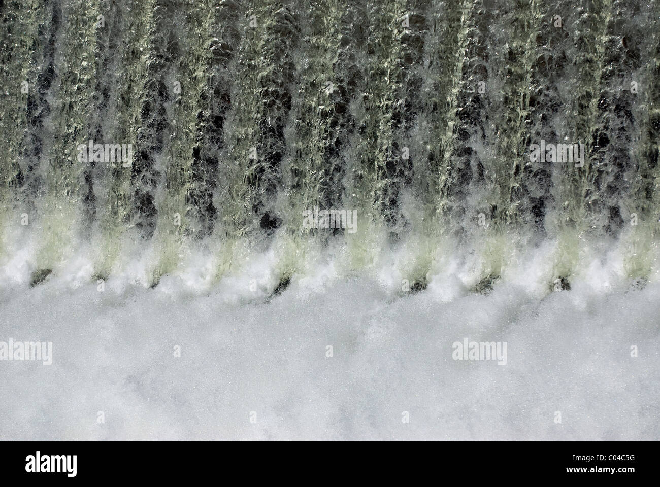 Waterfall under a dam by lake Stock Photo - Alamy