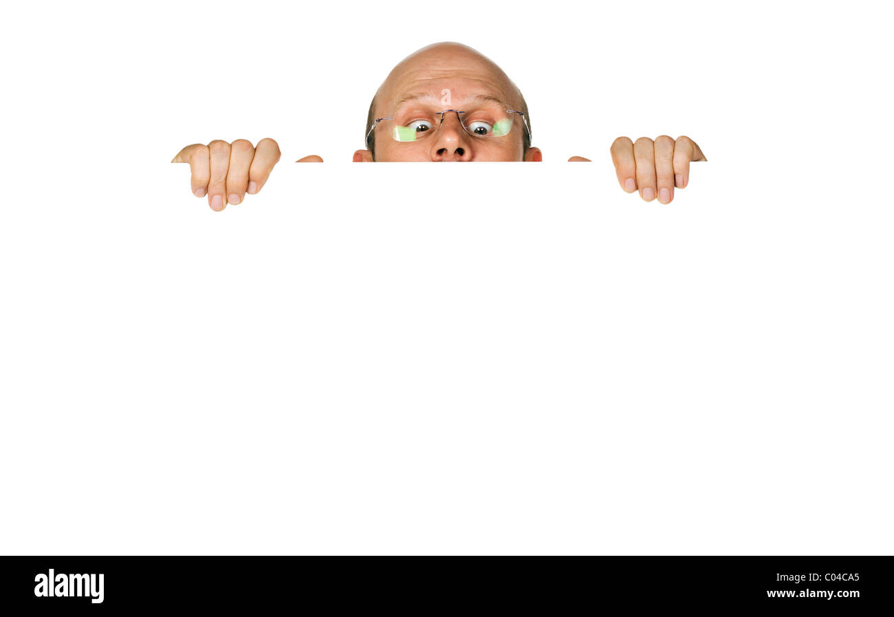 Funny portrait of curious man looking over white wall or sign. Isolated ...