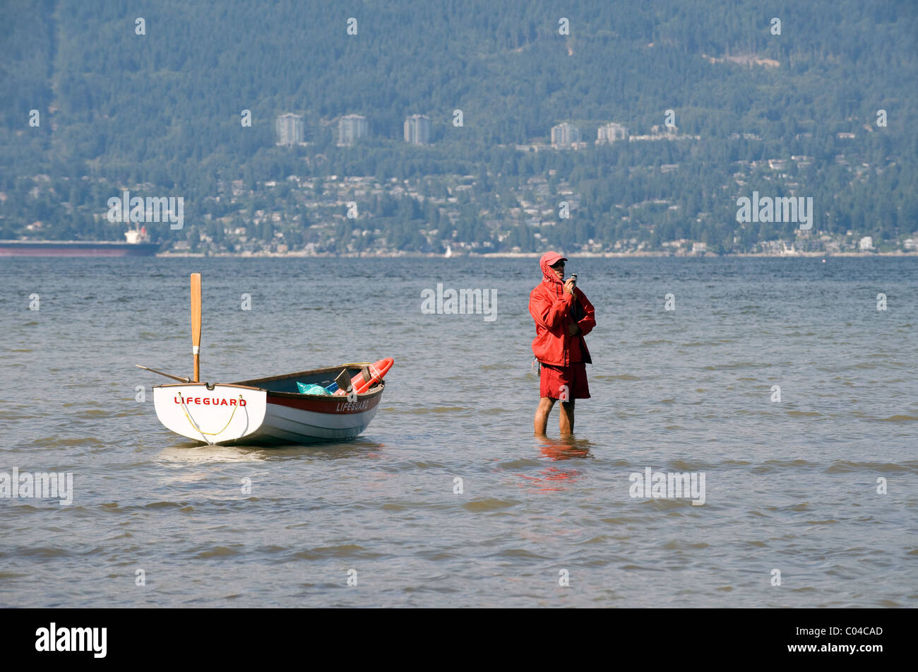 Lifeguard man standing in ocean Stock Photo - Alamy