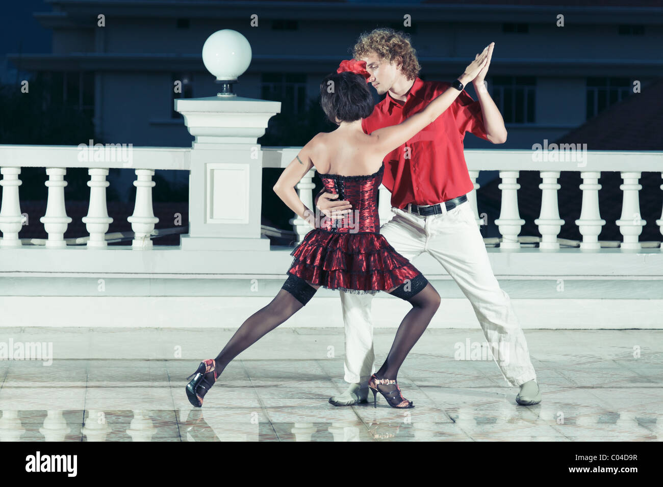 Couple dancing tango at the night time Stock Photo - Alamy