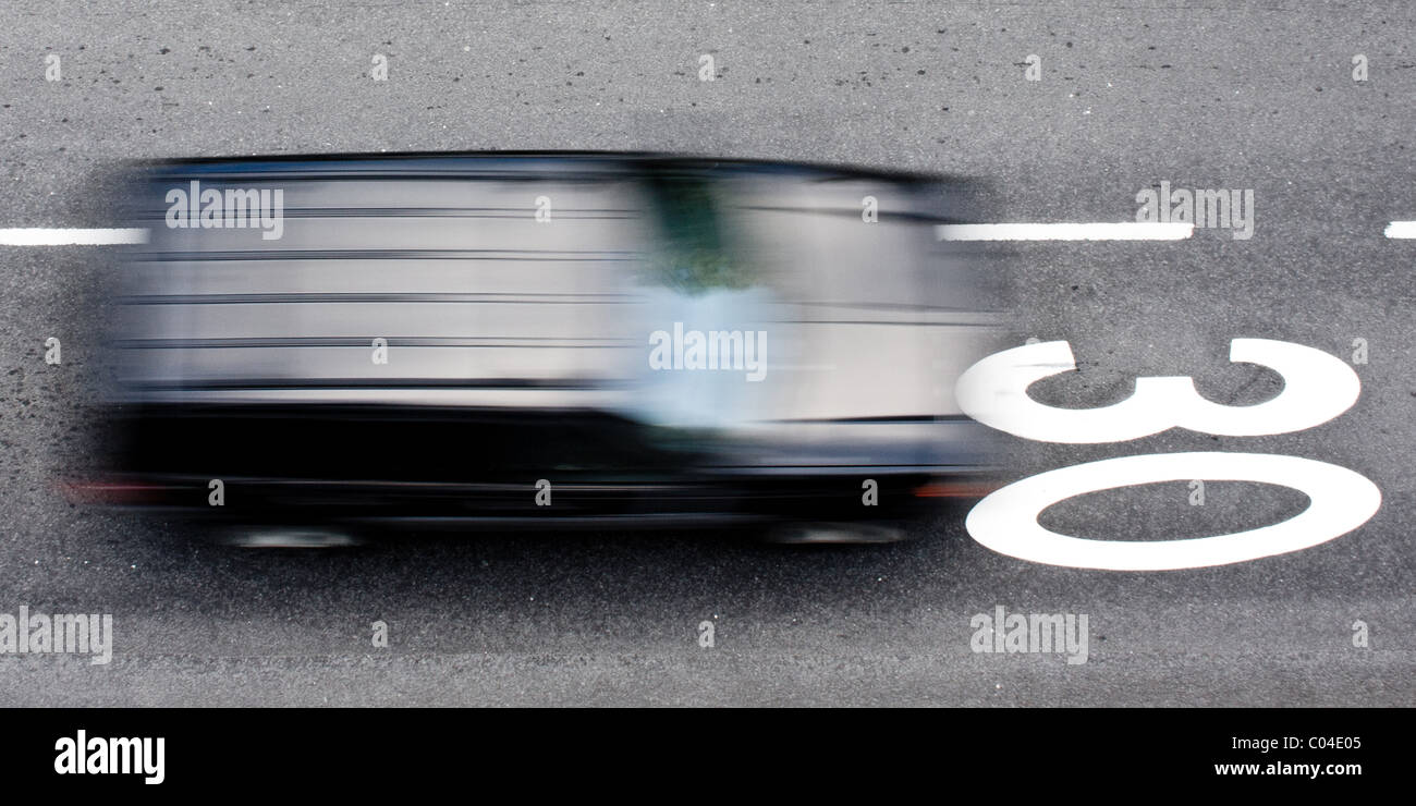 A car driving where the limit is 30 km/hour Stock Photo - Alamy