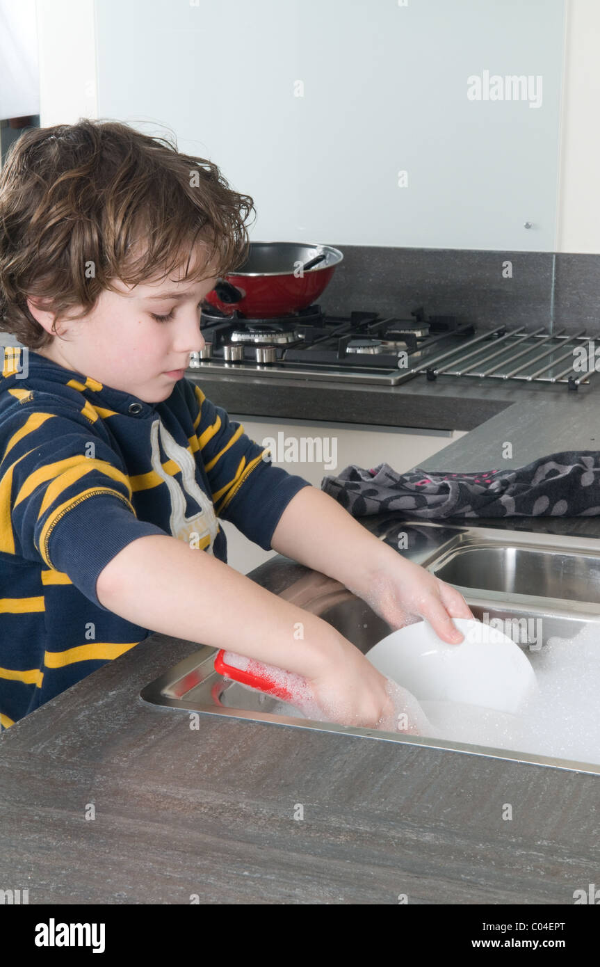 Boy doing the dishes in a modern kitchen Stock Photo - Alamy