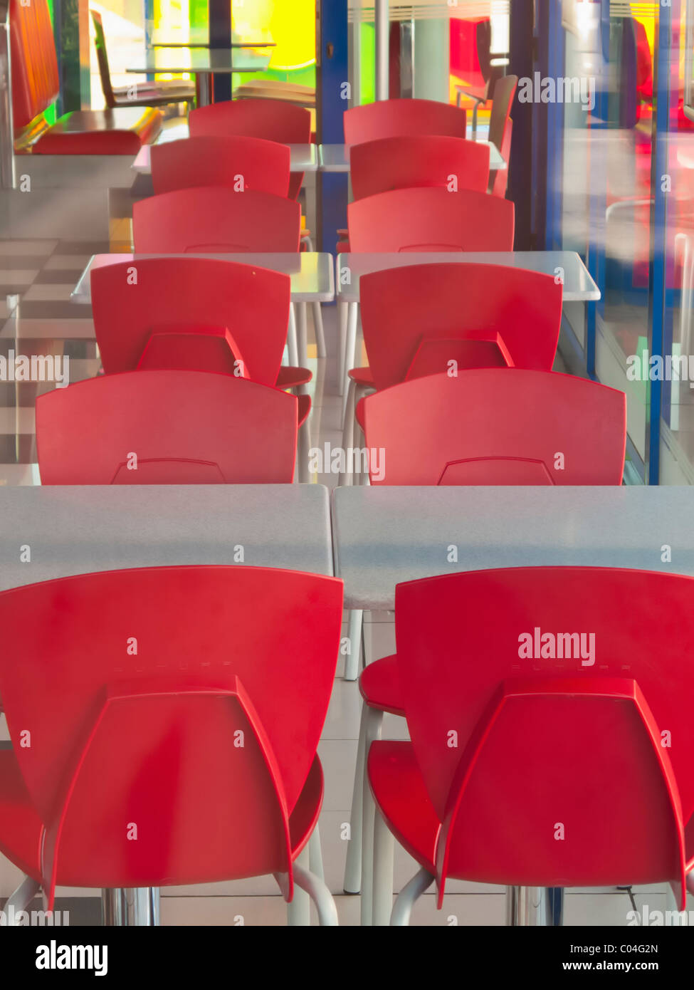 Chairs and tables seen through window of empty Burger King fast food ...