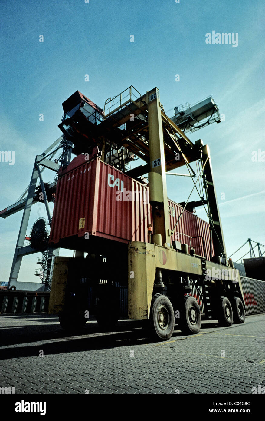Straddle carrier handling 40 foot container on a container terminal in ...