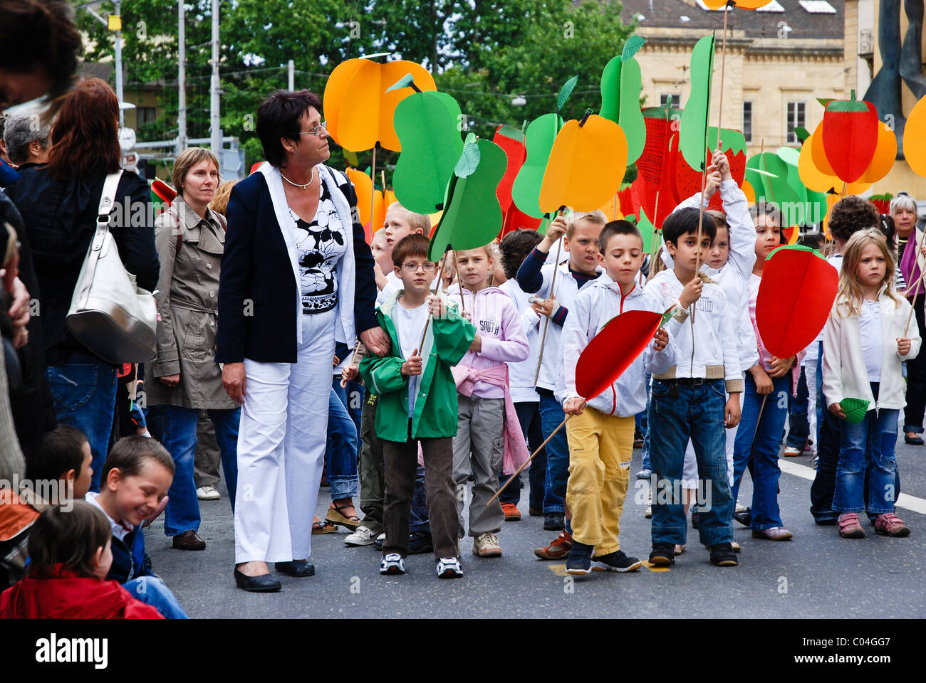 Children carrying signs playing, parade, with teacher, Charles Lupica ...