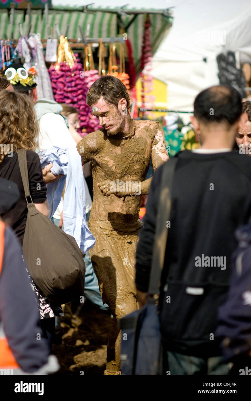Young man covered in mud and dancing at WOMAD Festival, Malmesbury ...