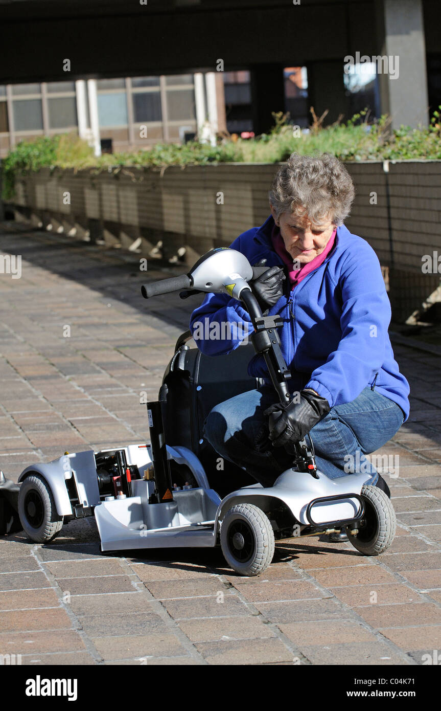 Mobility scooter user assembling an ultra light battery powered machine ...