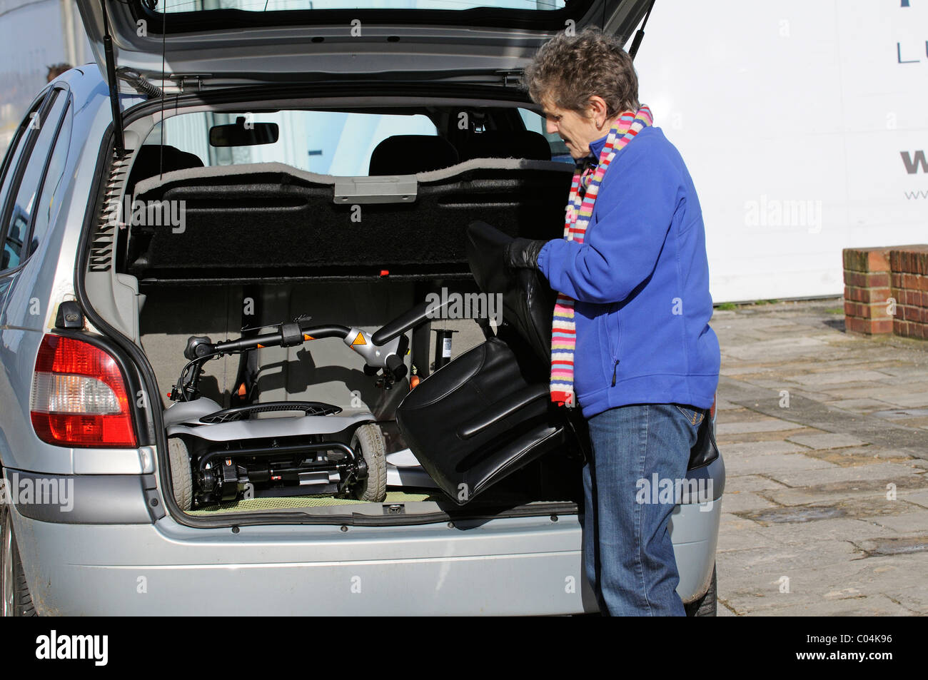 Mobility scooter user assembling an ultra light battery powered machine ...