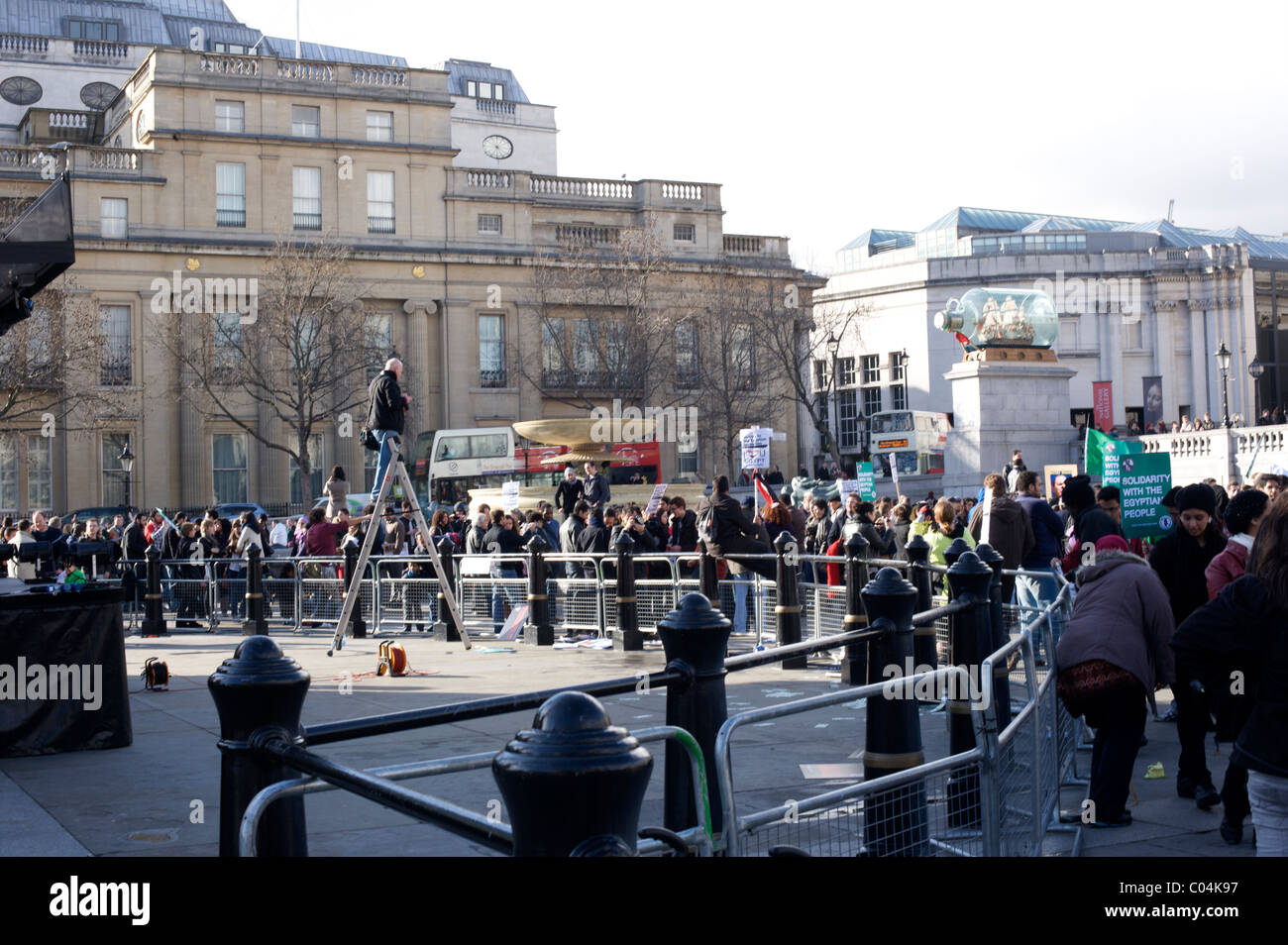 Photographer on step ladder working for Amnesty International at ...