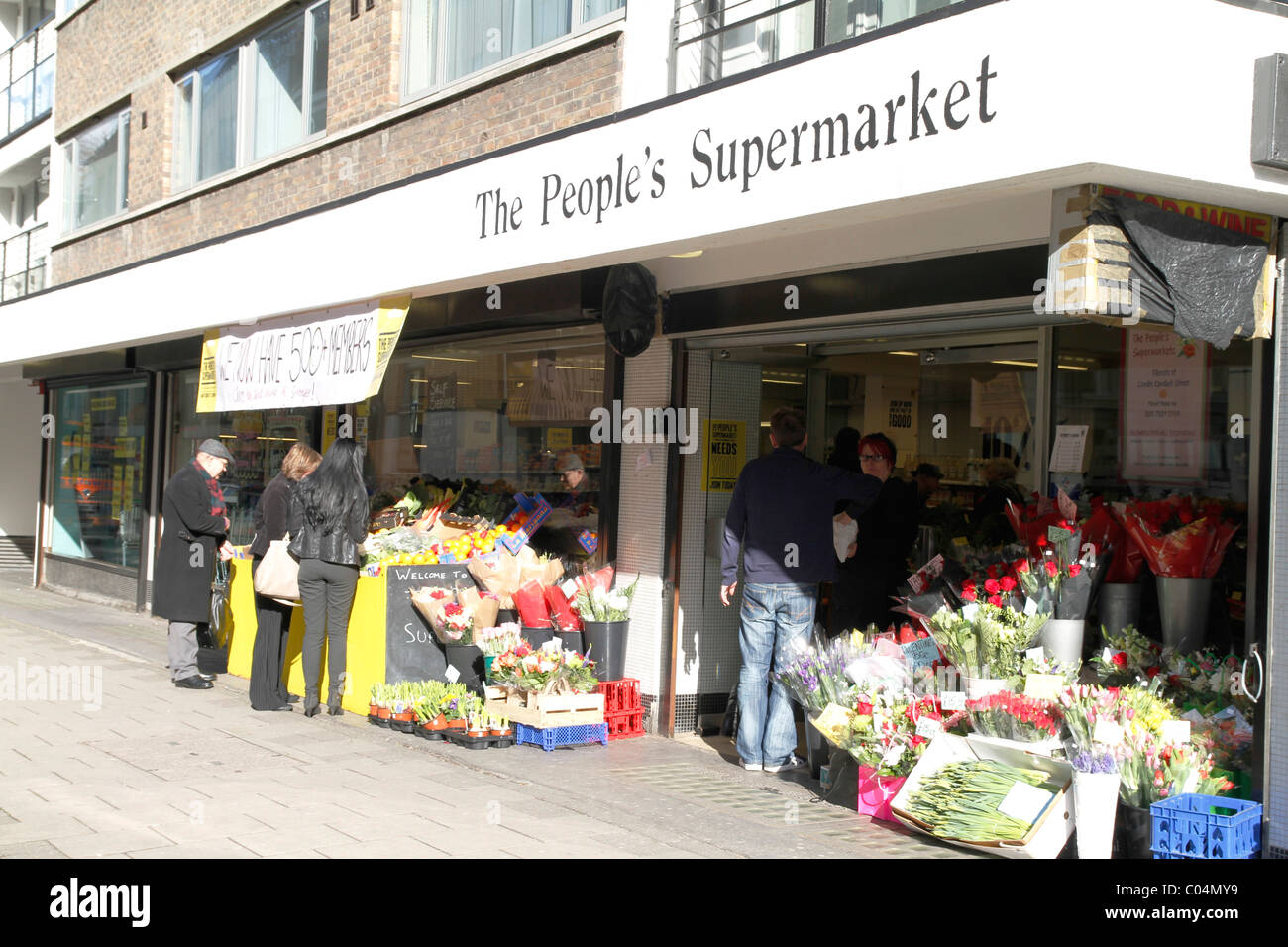 UK. SHOPPERS AT A PEOPLE'S SUPERMARKET, A SUSTAINABLE FOOD CO-OPERATIVE ...