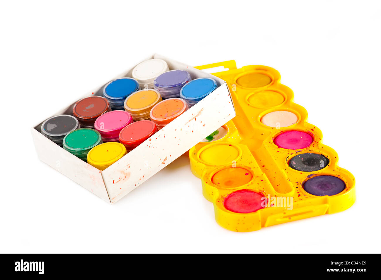 Set of used multicolored watercolor paint in containers on white ...