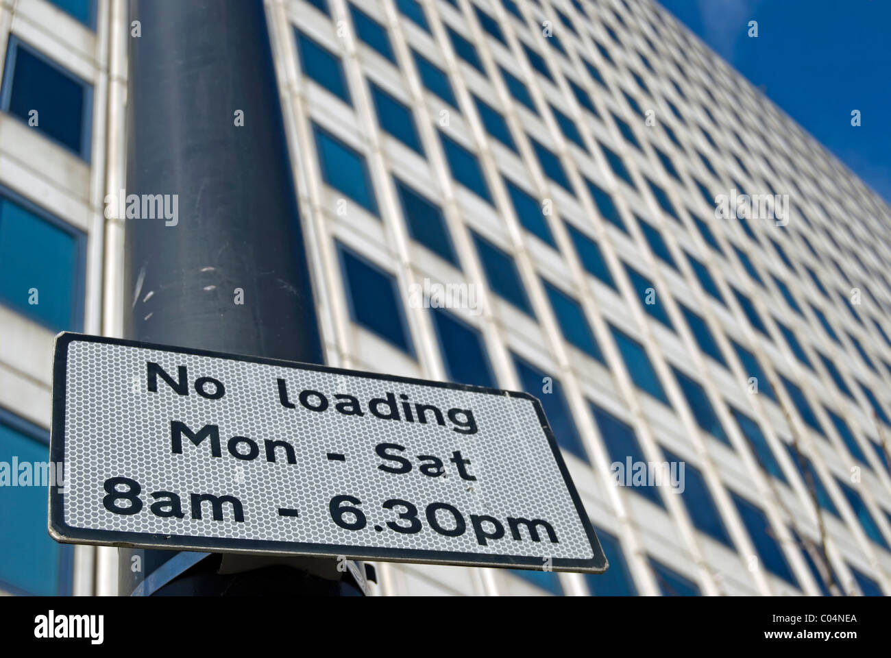 no loading sign with times and days of operation outside an office ...