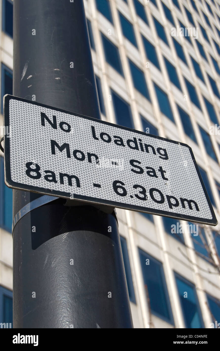 no loading sign with times and days of operation outside an office ...