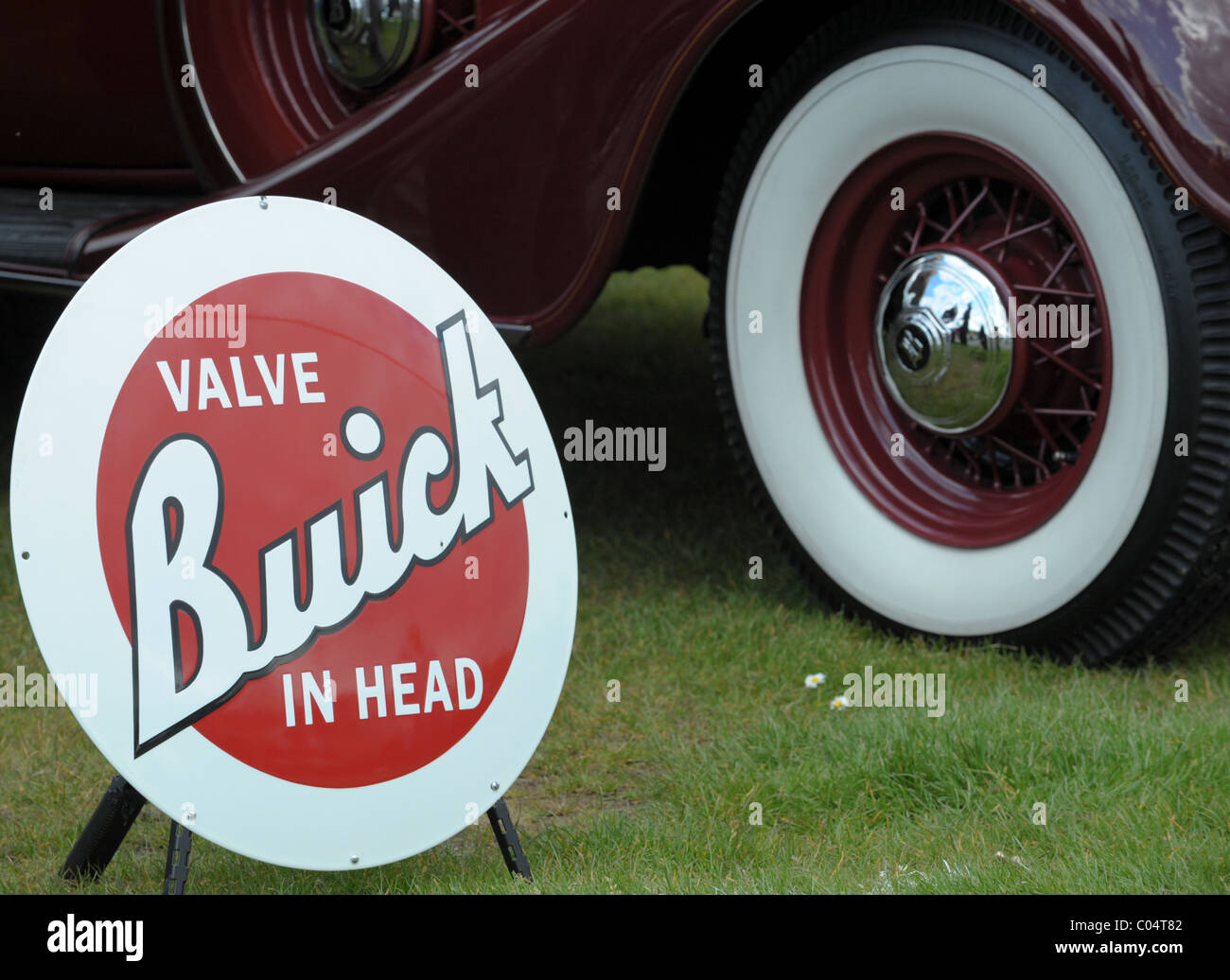 Vintage Valve Buick advertising sign next to front wheel of a classic ...