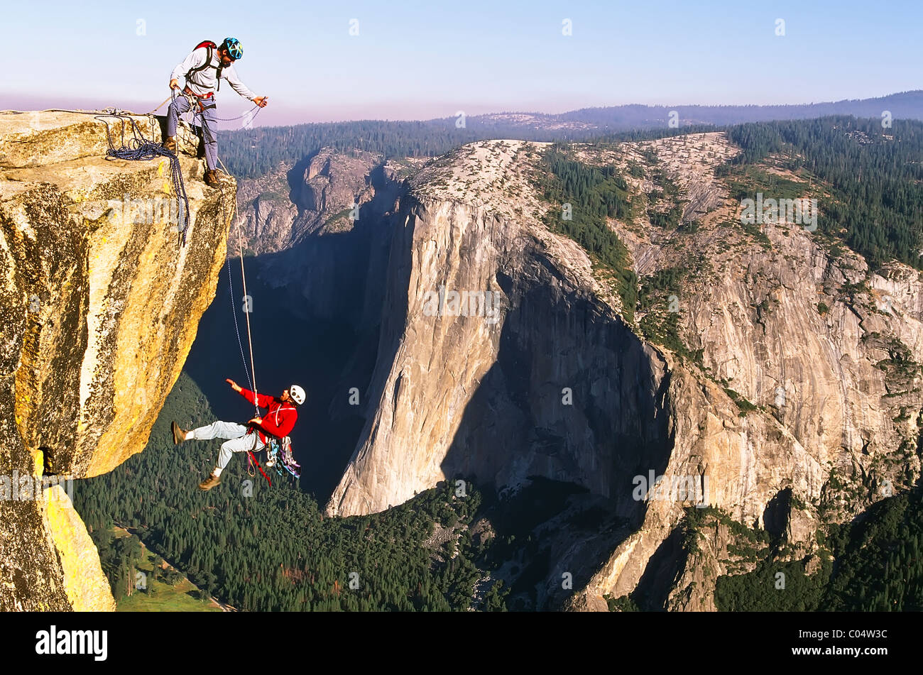 Team of climbers reaching the summit of a rock pinnacle Stock Photo - Alamy