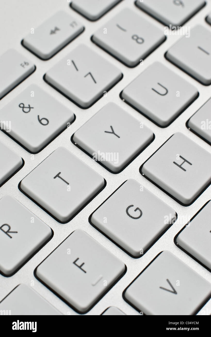 Closeup perspective of a modern aluminum keyboard, focus on center keys ...