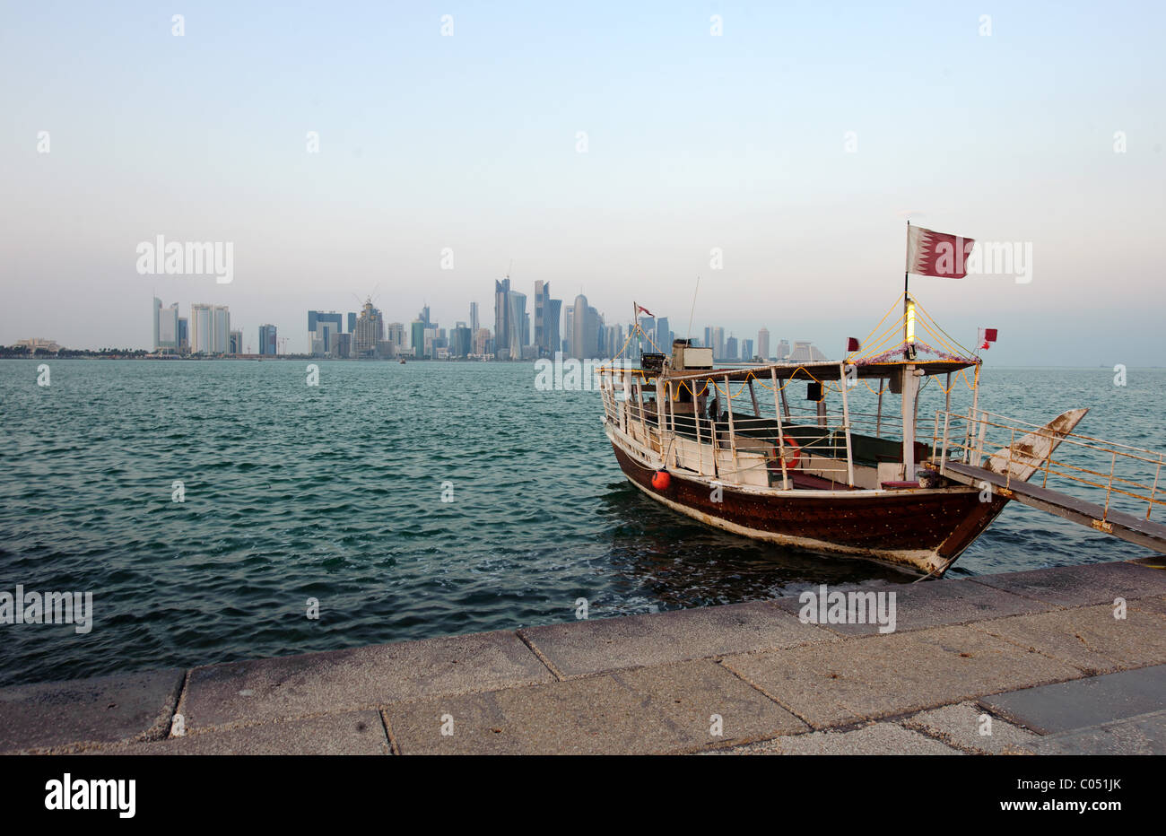 Traditional arabic Dhow boat on the Corniche Sea - Doha City Skyline ...