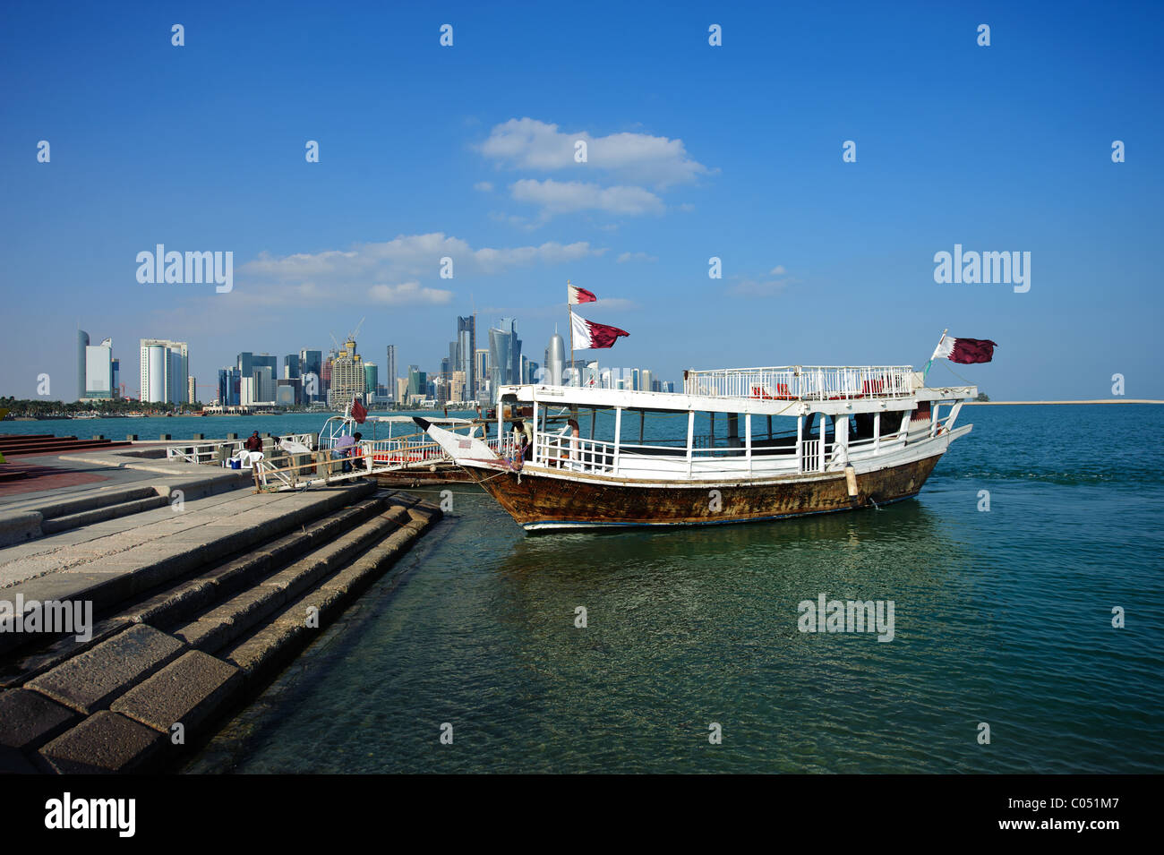 Traditional arabic Dhow River Taxi boat on the Corniche Sea - Doha City ...