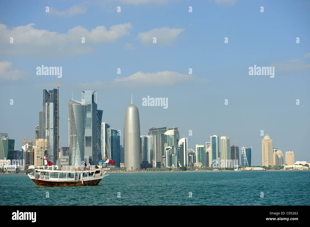 Traditional arabic Dhow boat on the Corniche Sea - Doha City Skyline ...