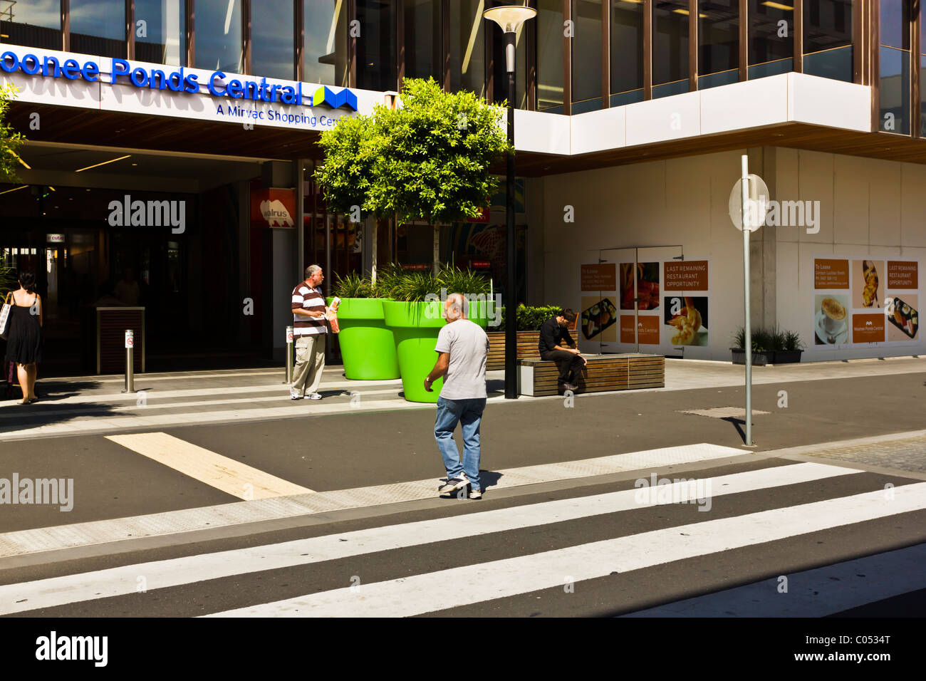 Men crossing street at pedestrian crossing Stock Photo - Alamy