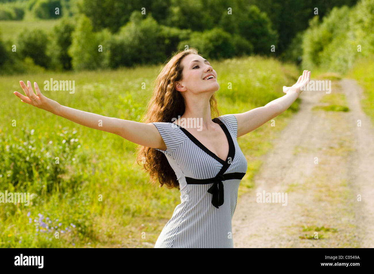 A beautiful girl enjoying summer sun rays Stock Photo - Alamy