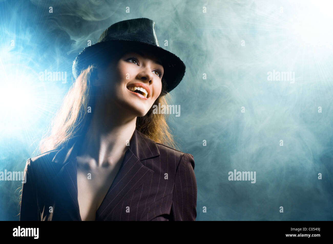 girl in the smoke enlightened with spotlights Stock Photo - Alamy