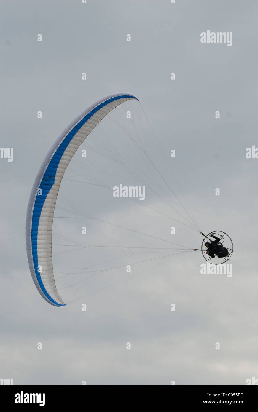 A flying powered paraglider Stock Photo - Alamy