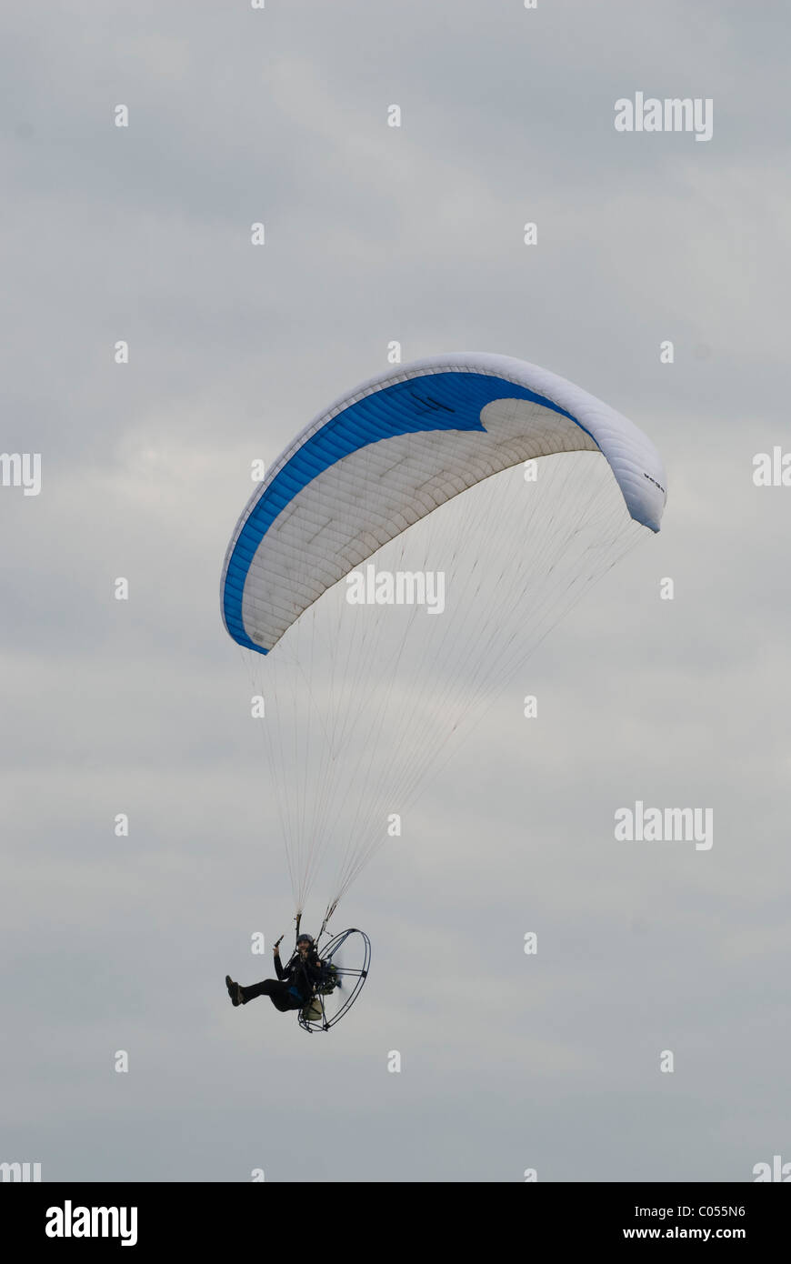 A flying powered paraglider Stock Photo - Alamy