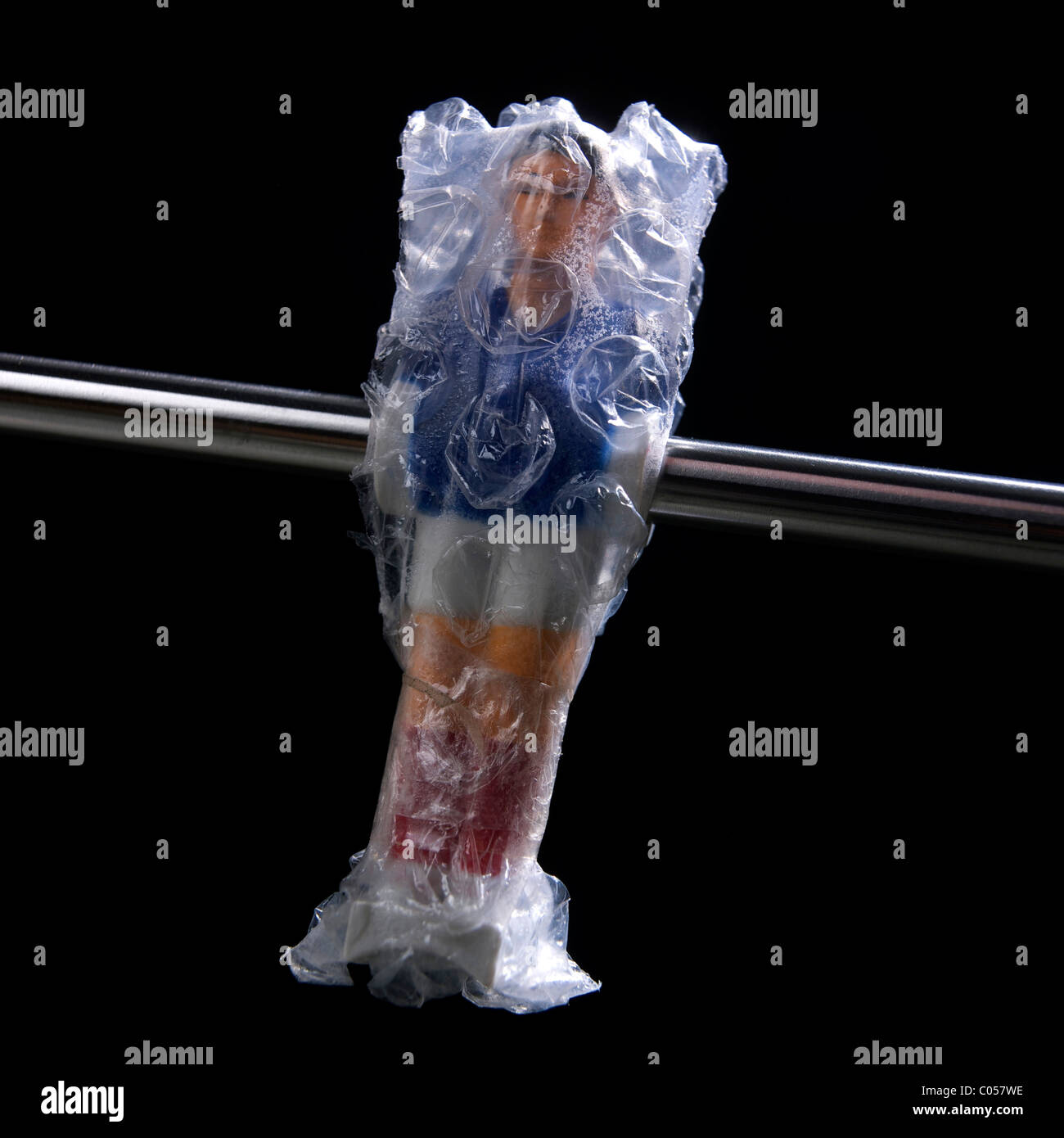 Football table player figure suspended on a rod in action pose with ...