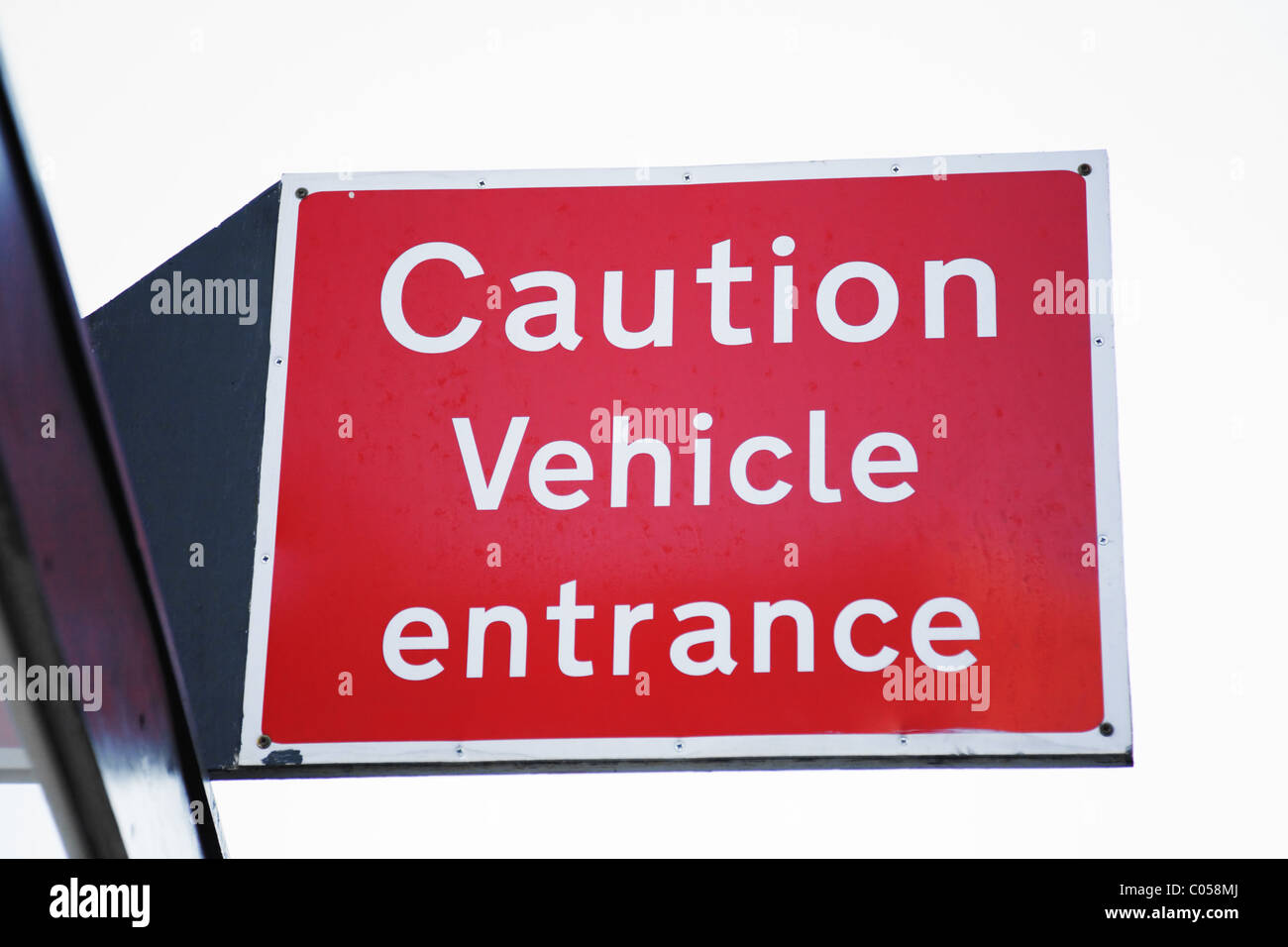 Caution vehicle entrance sign against a white background Stock Photo ...
