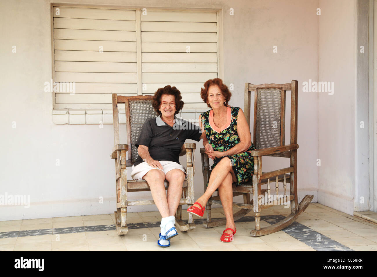 Two ladies sat on the porch in Cuba Stock Photo - Alamy