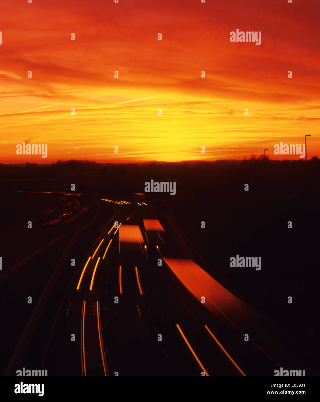 headlight trails of traffic travelling on the A1/M motorway at sunset ...