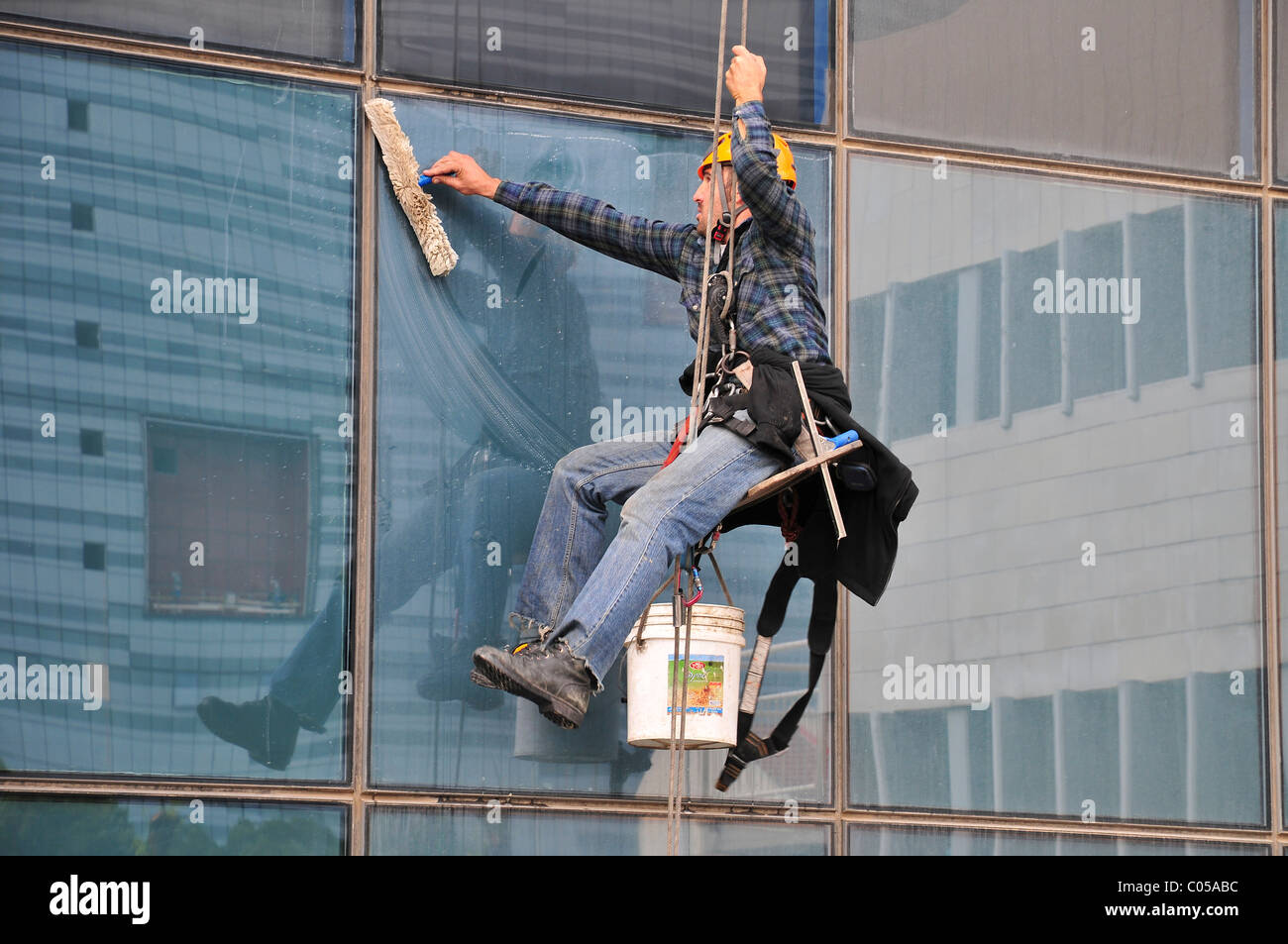 Window washer on side of skyscraper Stock Photo - Alamy
