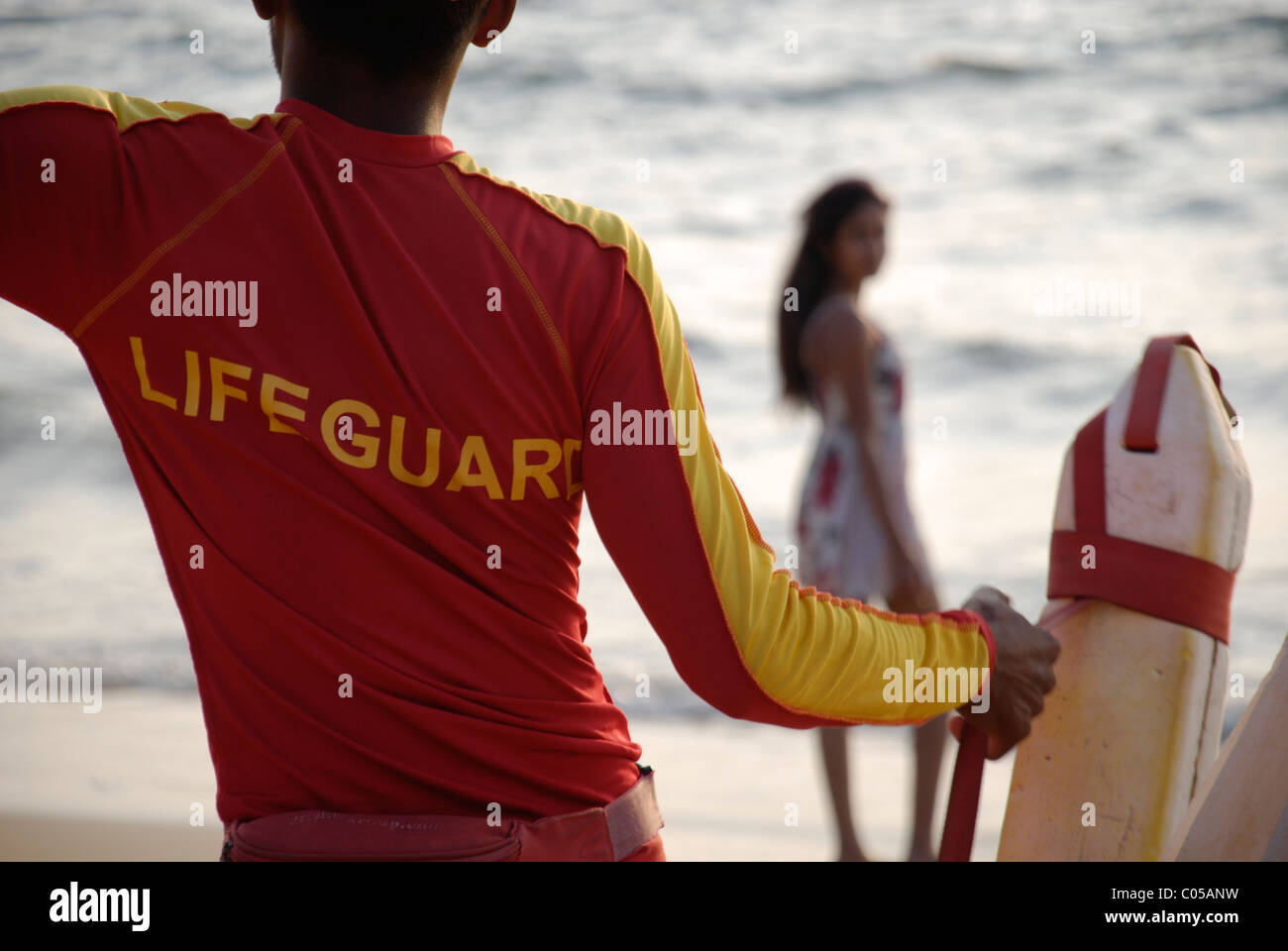 A lifeguard and a beauty eye each other on a beach in Goa Stock Photo ...