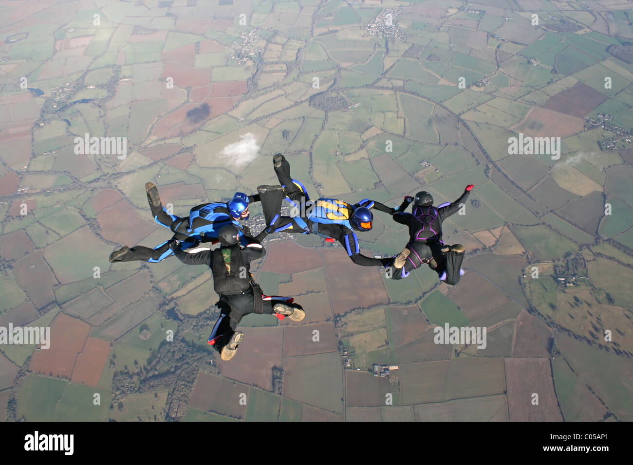 Four skydivers doing formations Stock Photo - Alamy