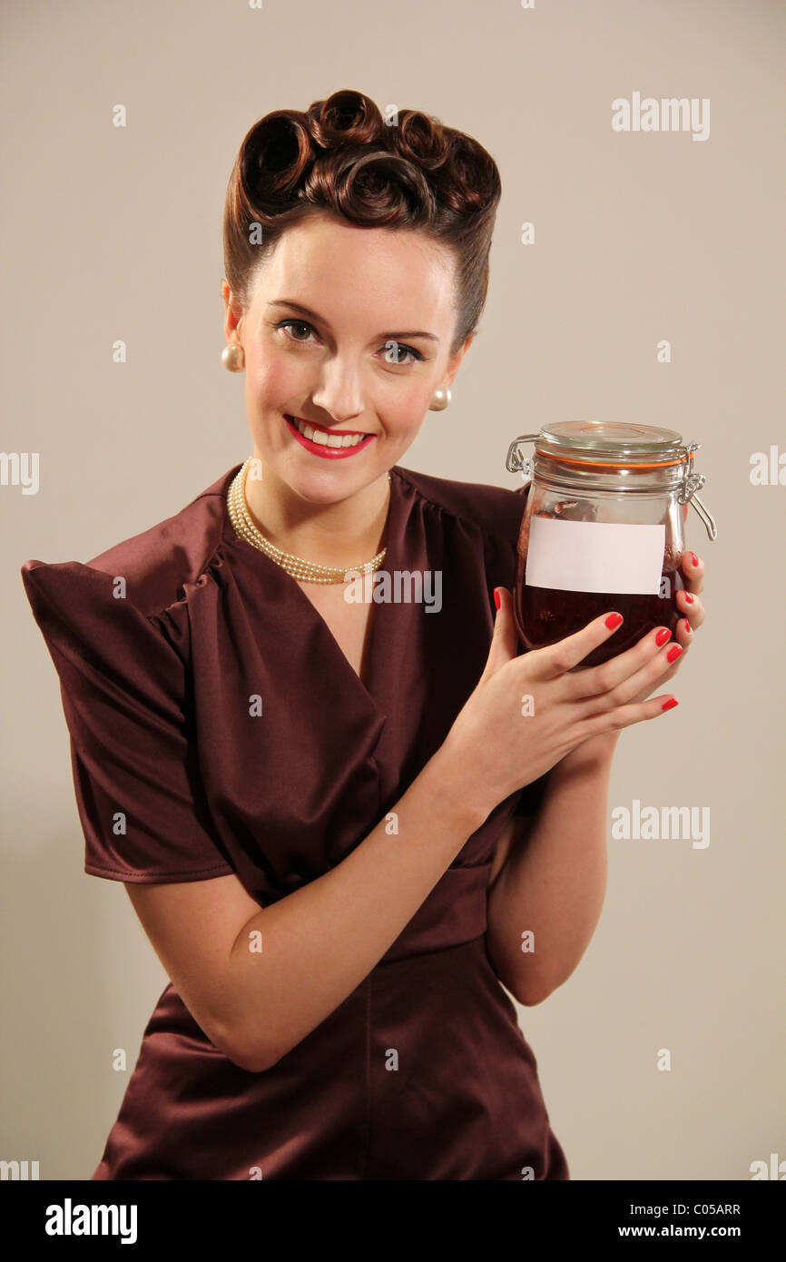 Old fashioned woman holding a jar Stock Photo - Alamy