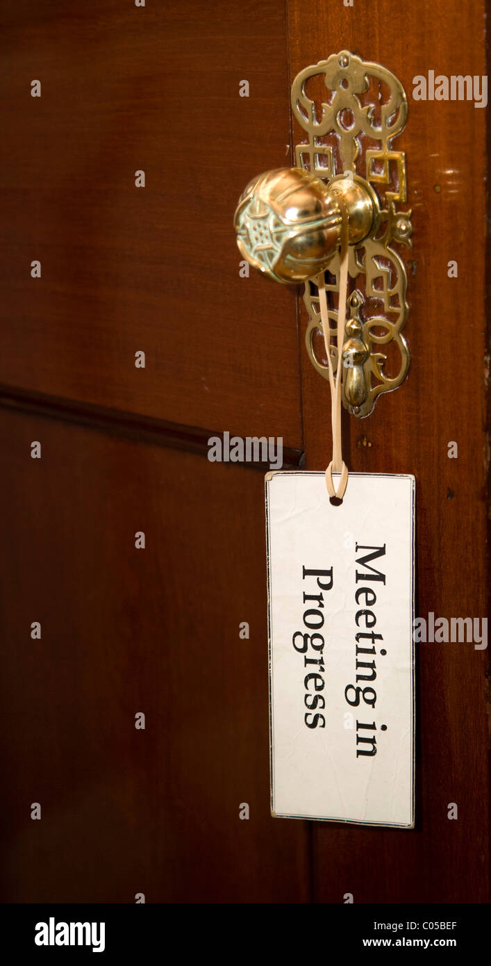 Meeting in Progress sign on a door handle Stock Photo - Alamy