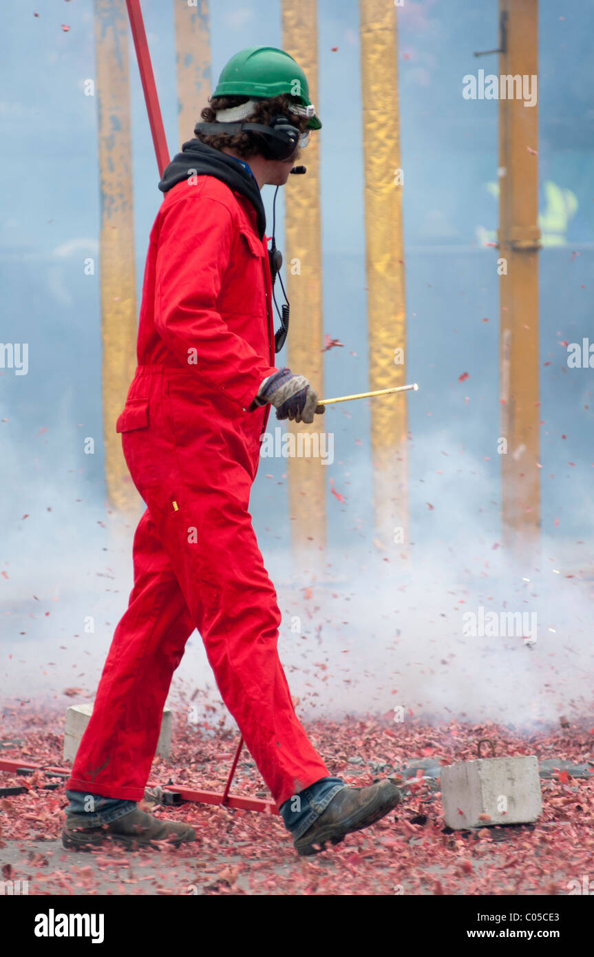 A man lighting Chinese fire crackers at Trafalgar square during the New ...