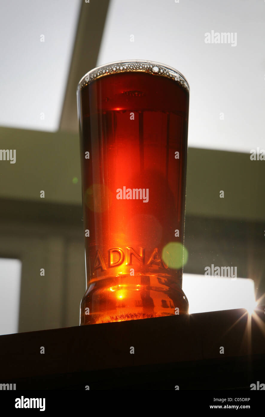 A pint of Adnams beer in an Adnams glass Stock Photo - Alamy