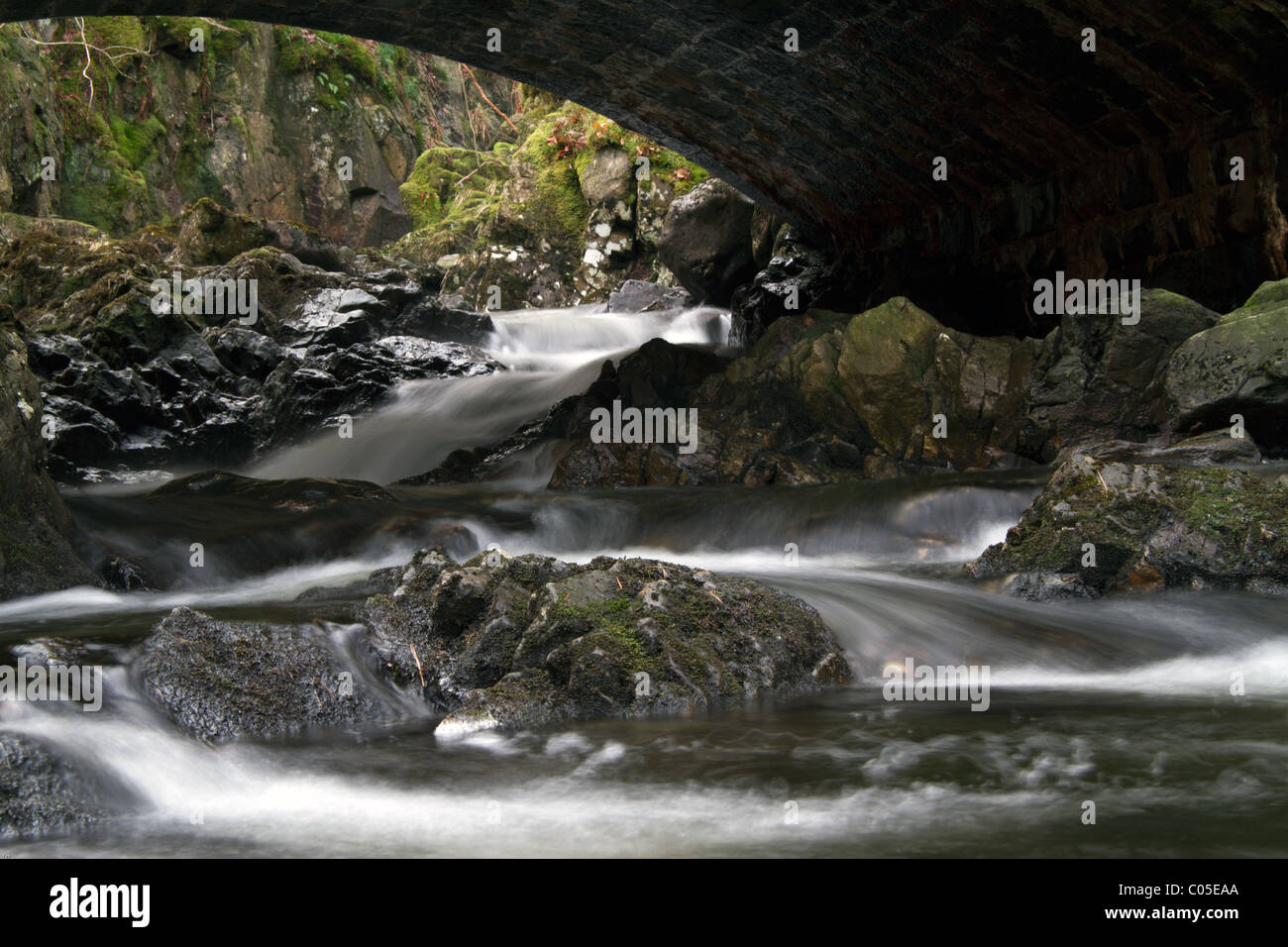 Small waterfall under a bridge beside Thirlmere reservoir Stock Photo ...