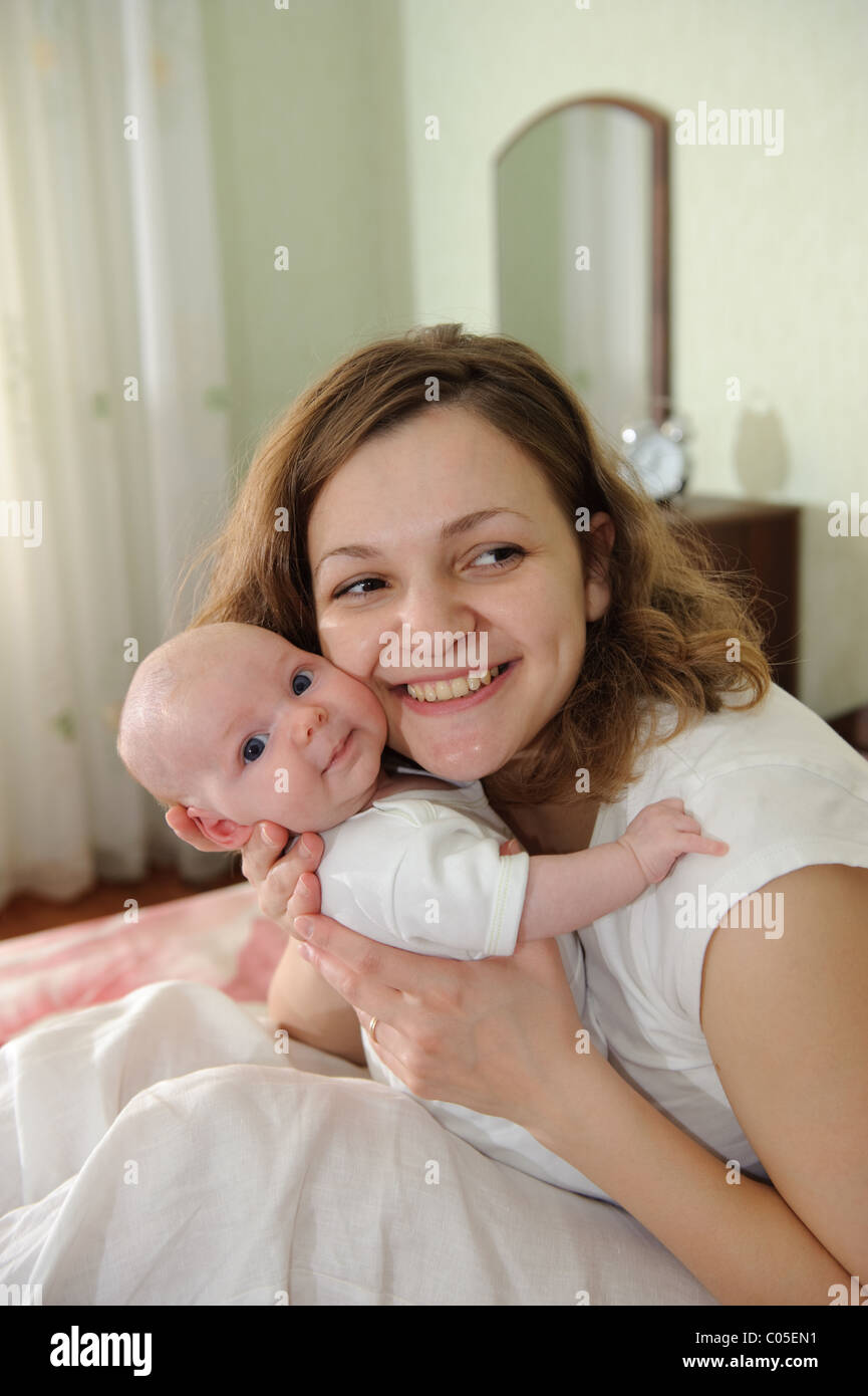 Young mother embracing her little baby Stock Photo - Alamy