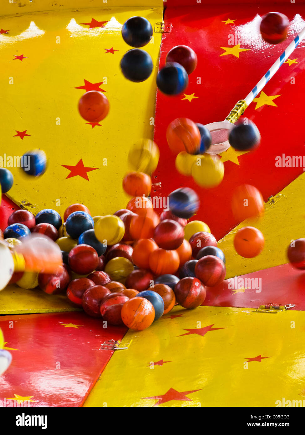 A colourful colorful image of a fairground game in red and yellow Stock ...