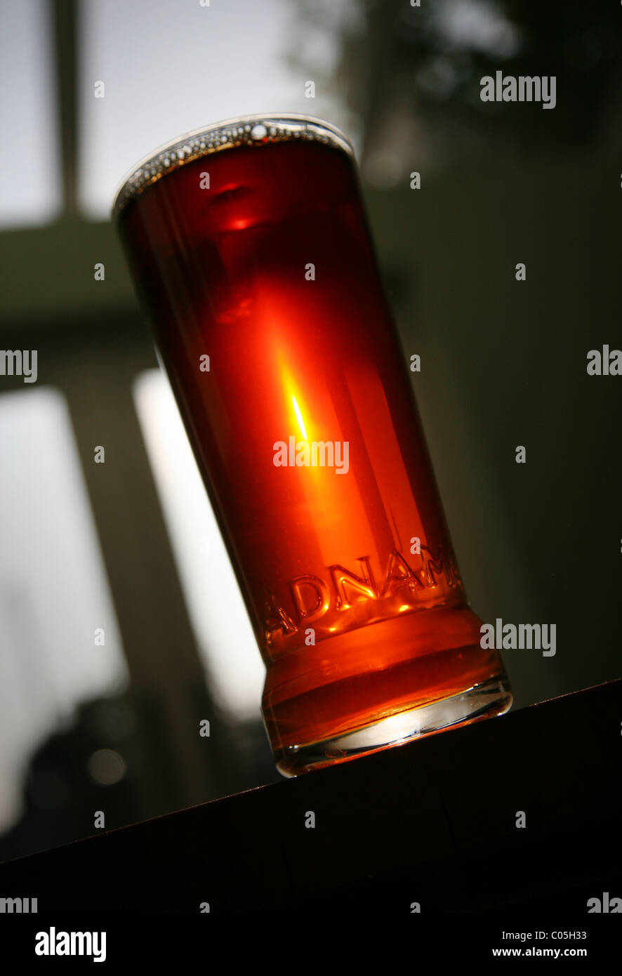 A pint of Adnams beer in an Adnams glass Stock Photo - Alamy