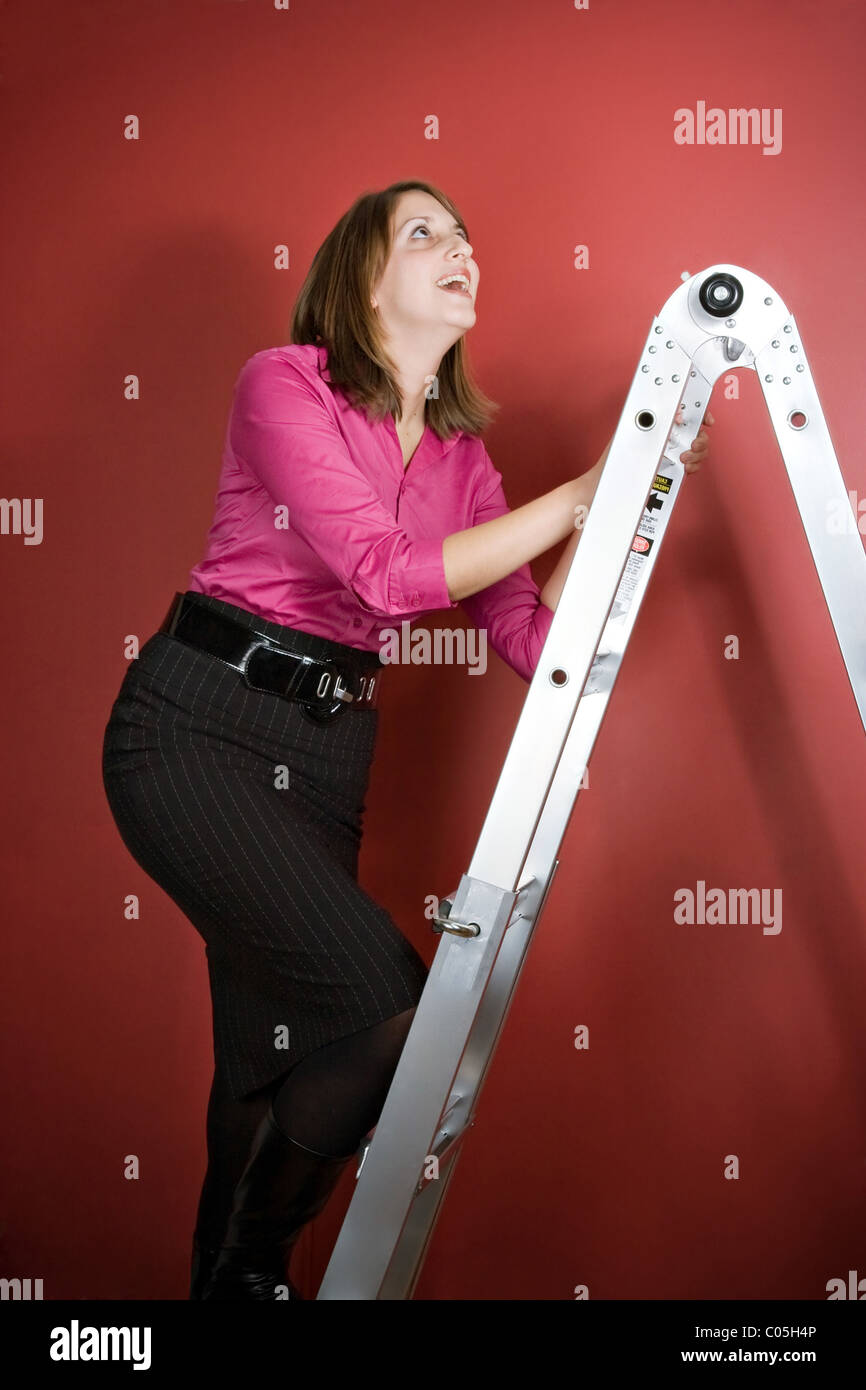 A woman climbs a ladder hi-res stock photography and images - Alamy