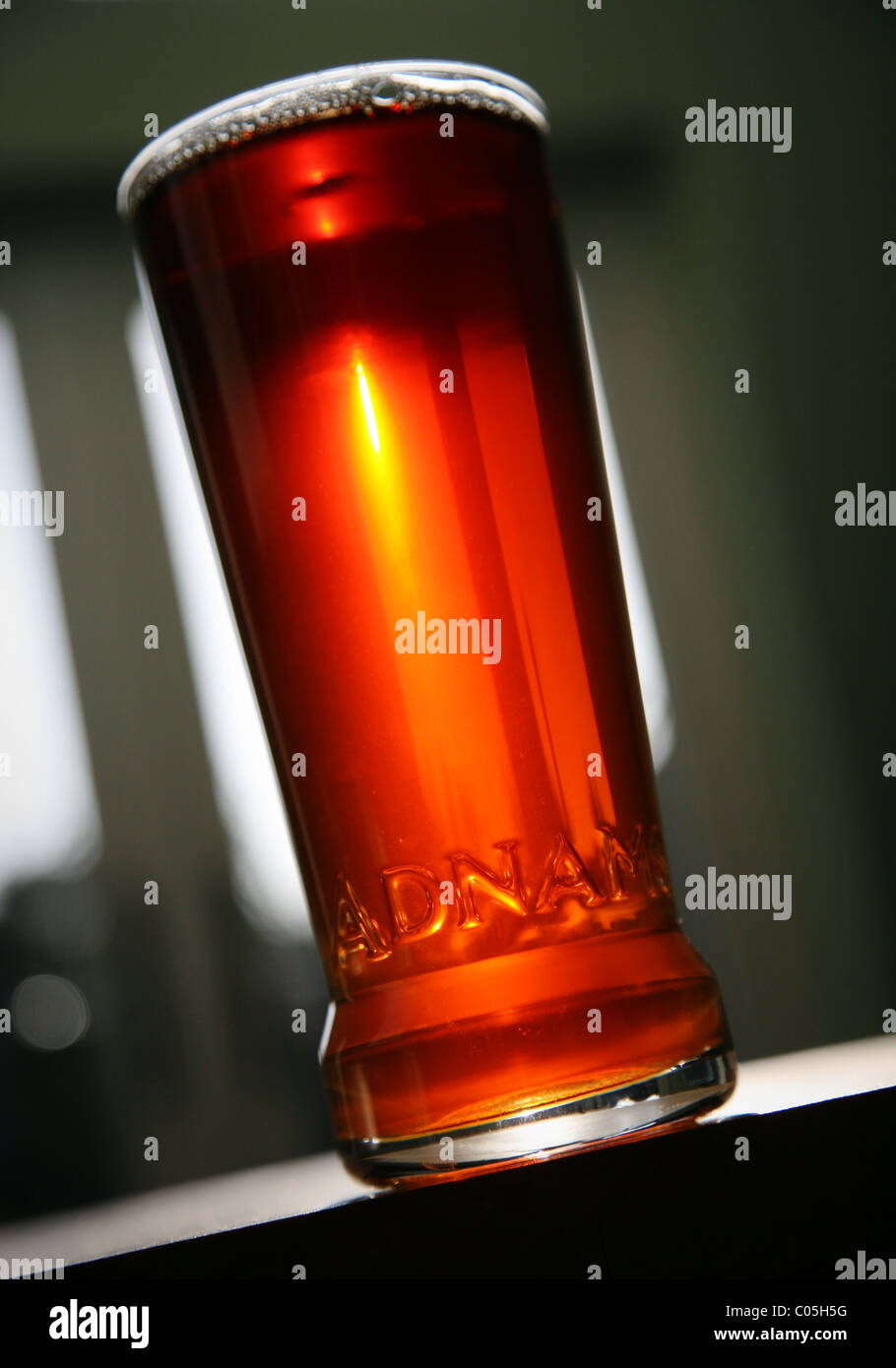 A pint of Adnams beer in an Adnams glass Stock Photo - Alamy
